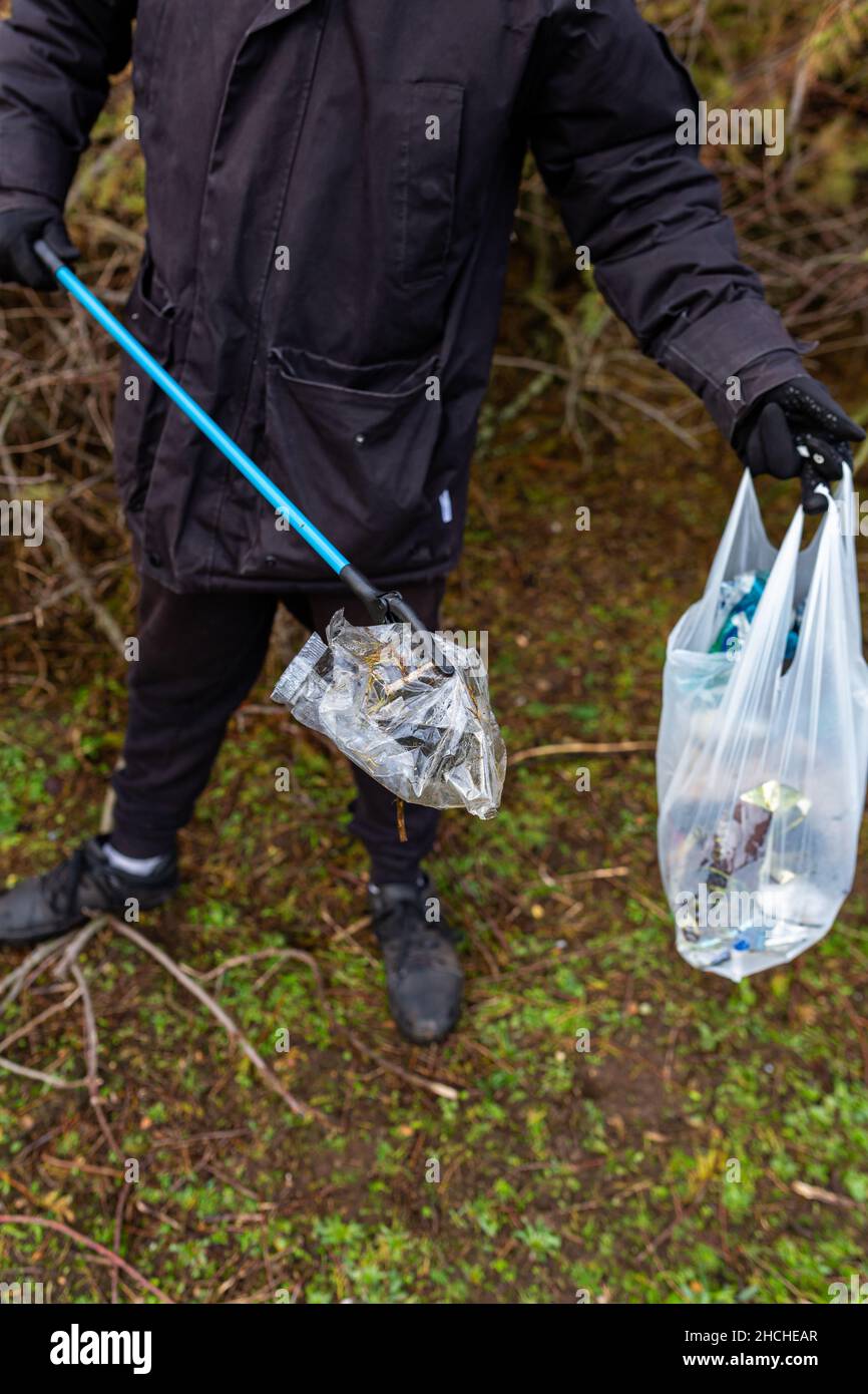 Bawdsey, Suffolk, UK January 06 2021: An adult male doing a beach clean ...
