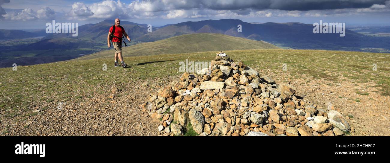 Walker at the summit of Great Dodd fell above St Johns in the Vale ...