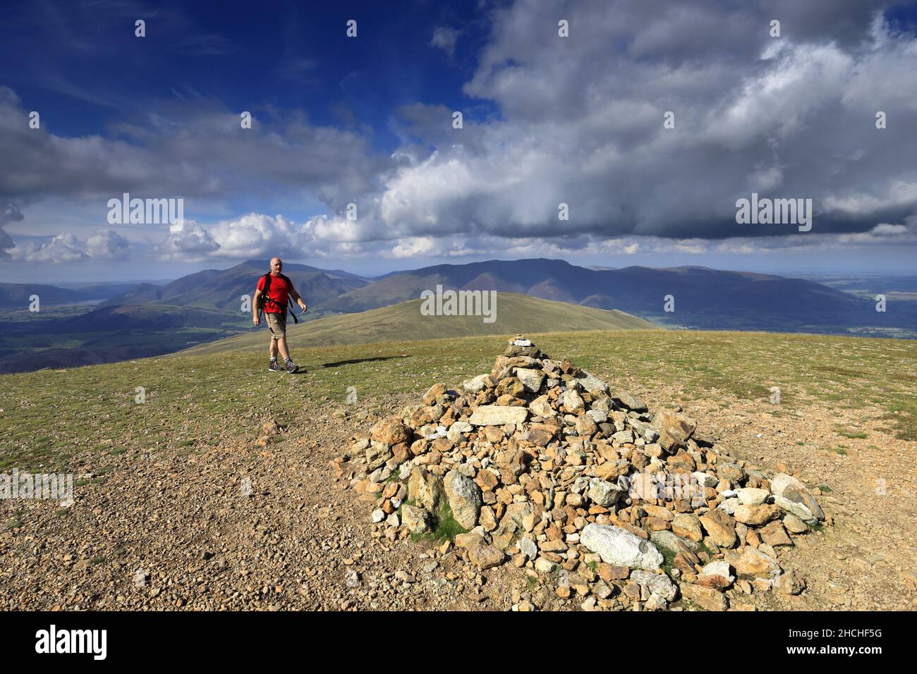 Walker at the summit of Great Dodd fell above St Johns in the Vale ...