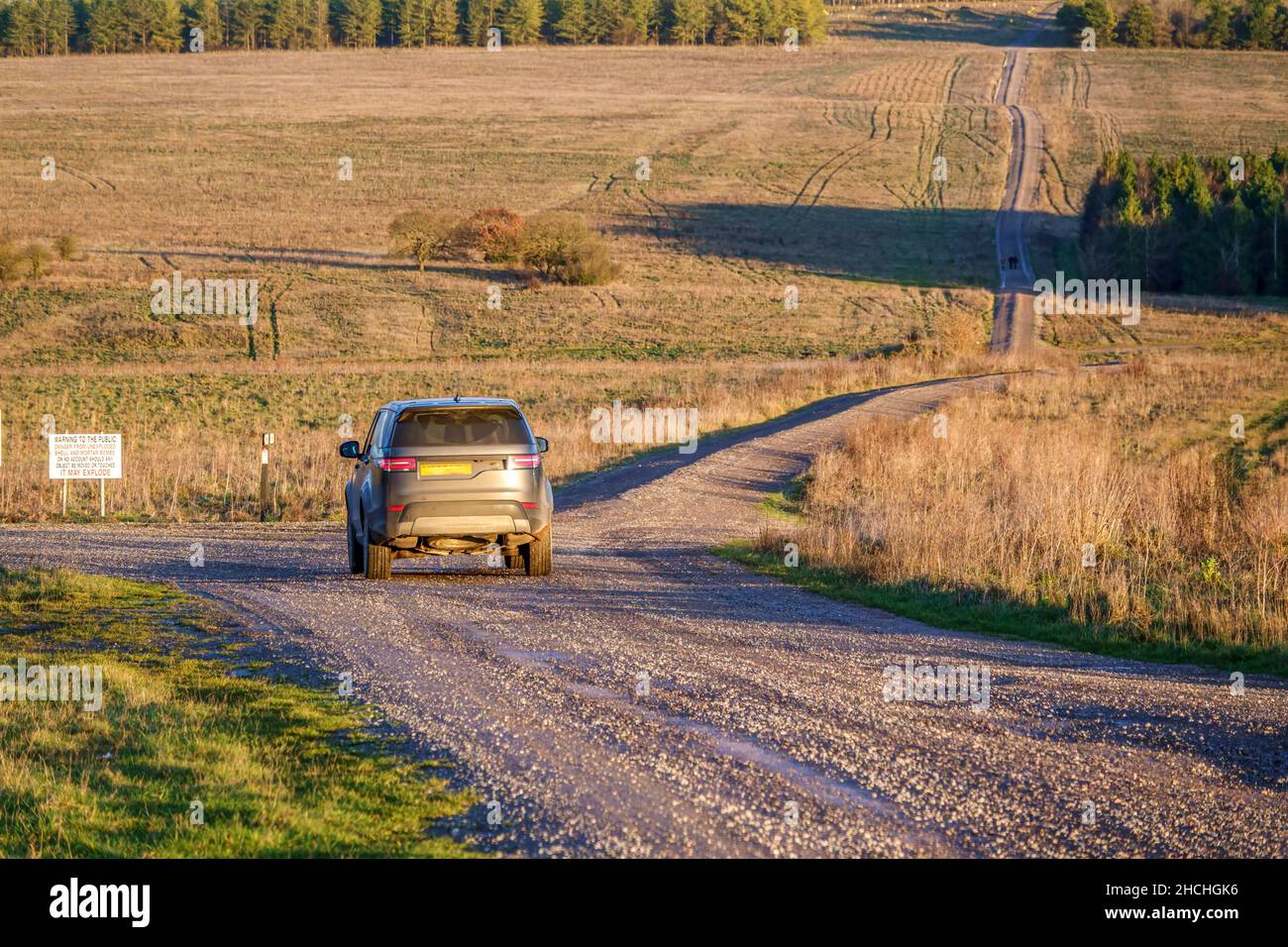 a Land Rover Discovery 5 driving along an unmade stone track road Stock ...