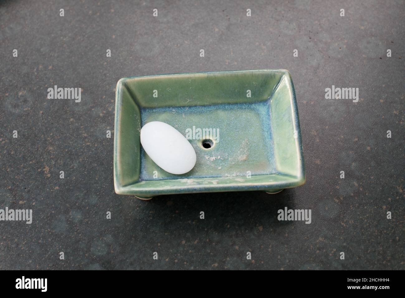 Small amount of blue soap in a ceramic soap dish Stock Photo - Alamy