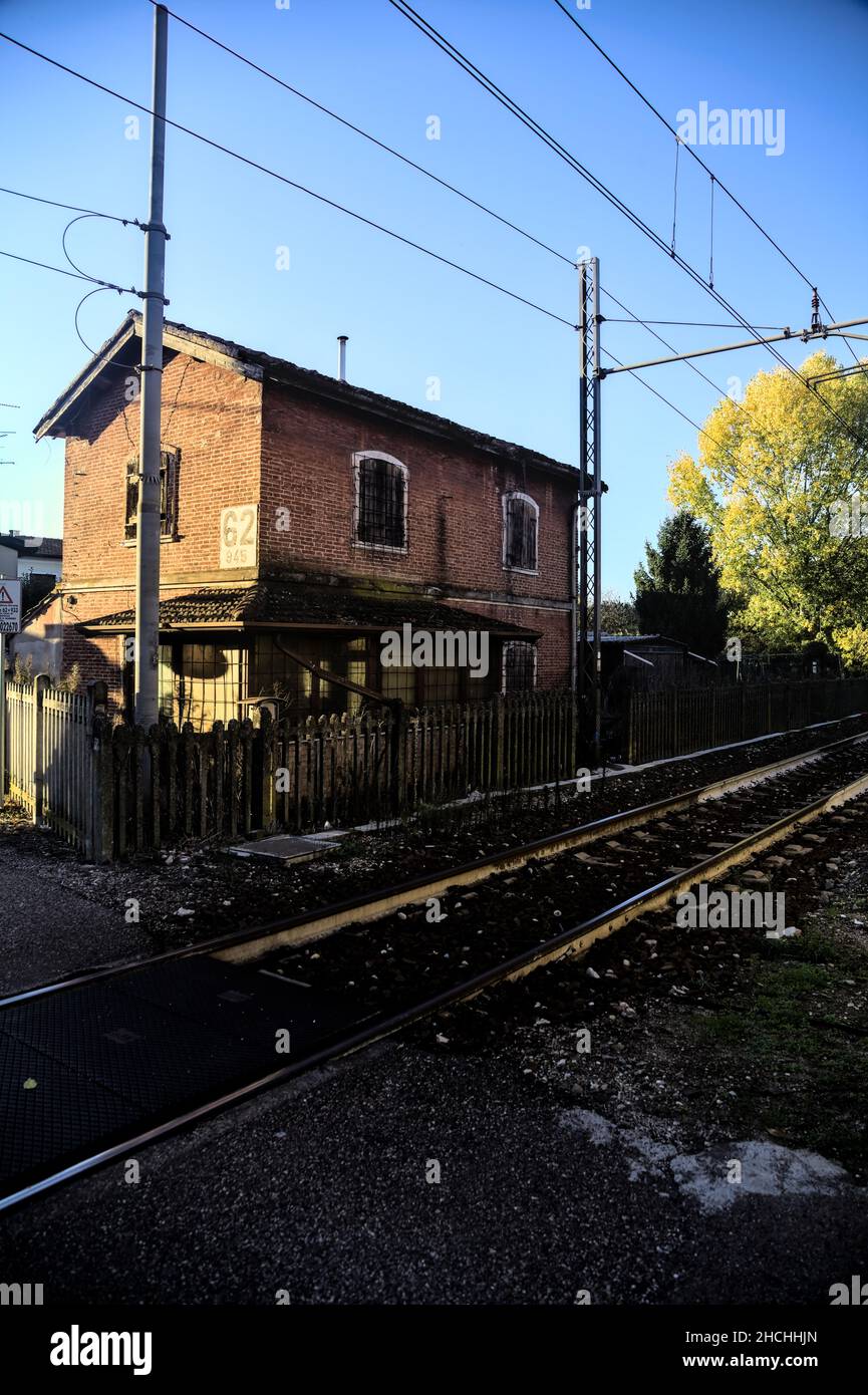 Old brick building by the edge of a railroad crossing at sunset Stock ...