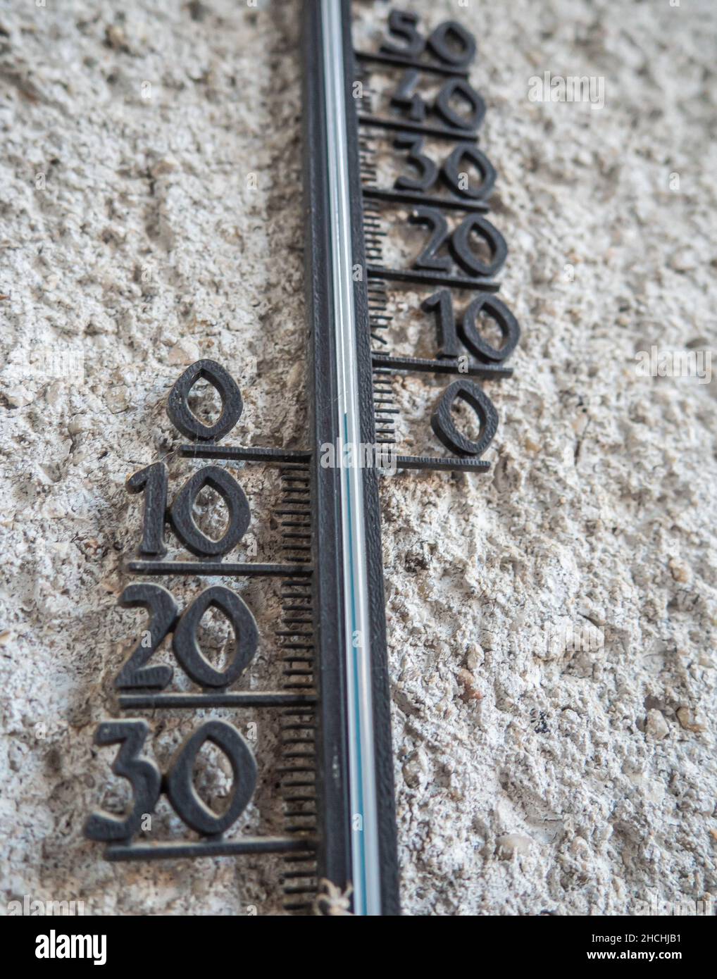 Vertical shot of an outdoor thermometer on a concrete wall Stock Photo ...