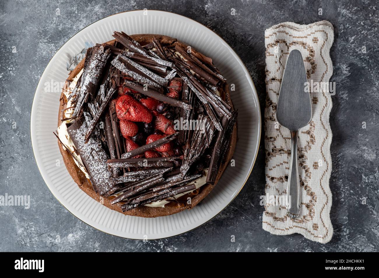Top view of chocolate marquise cake with red berries resting on a ...