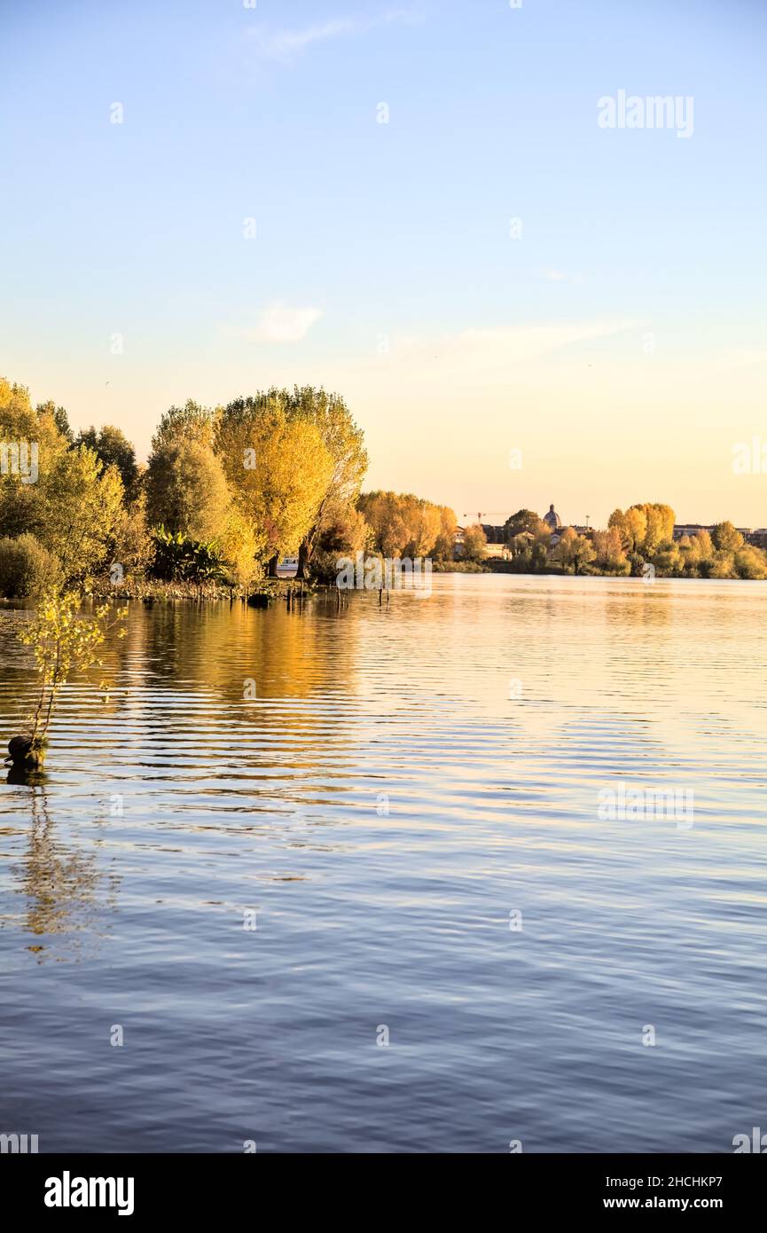 Shore at sunset that stretches on a river Stock Photo - Alamy