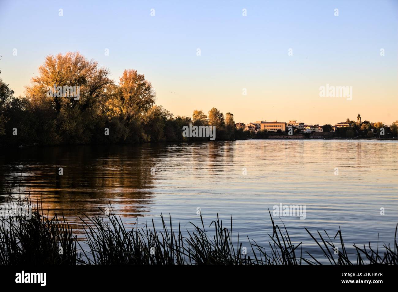 Shore at sunset that stretches on a river Stock Photo - Alamy