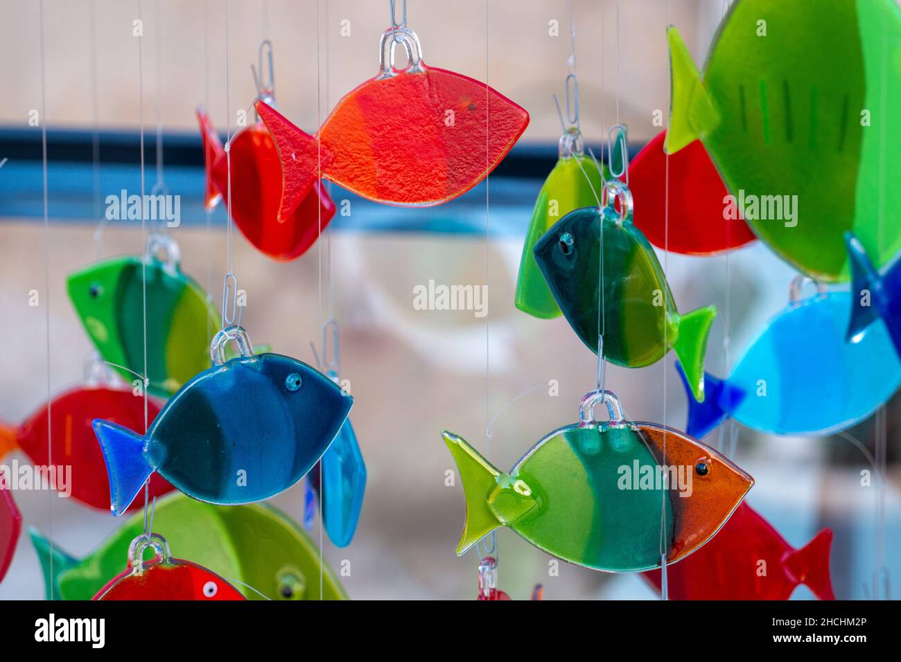 colorful hanging stained glass fish artwork hanging on the market Stock ...