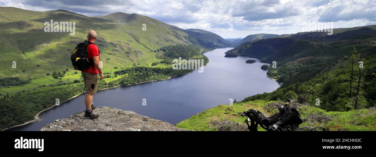 Walker at the summit cairn of Raven Crag fell overlooking Thirlmere ...