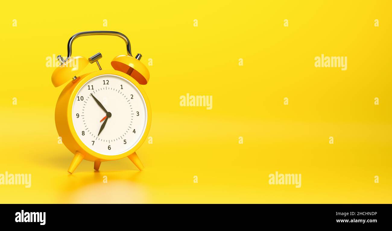 Yellow vintage alarm clock with bright yellow background. Minimal ...
