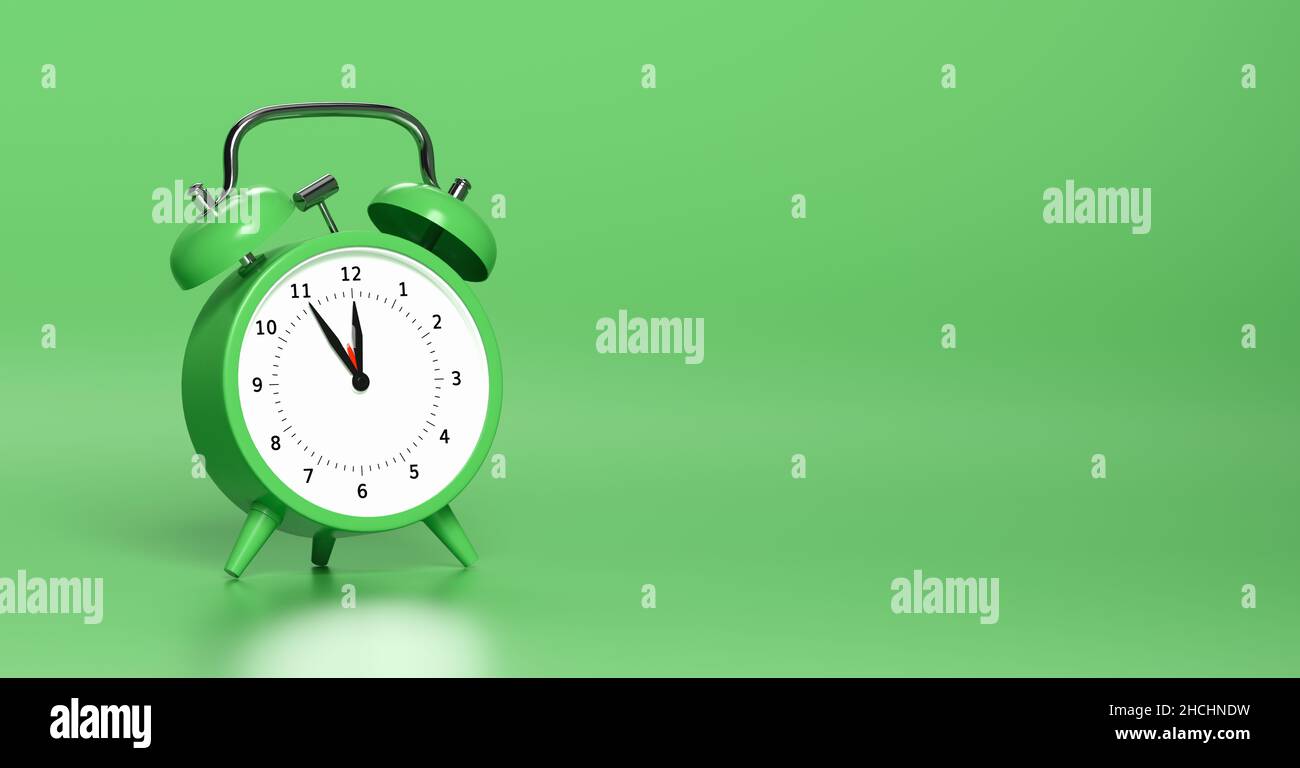 Green vintage alarm clock point to five minutes to twelve o'clock with ...