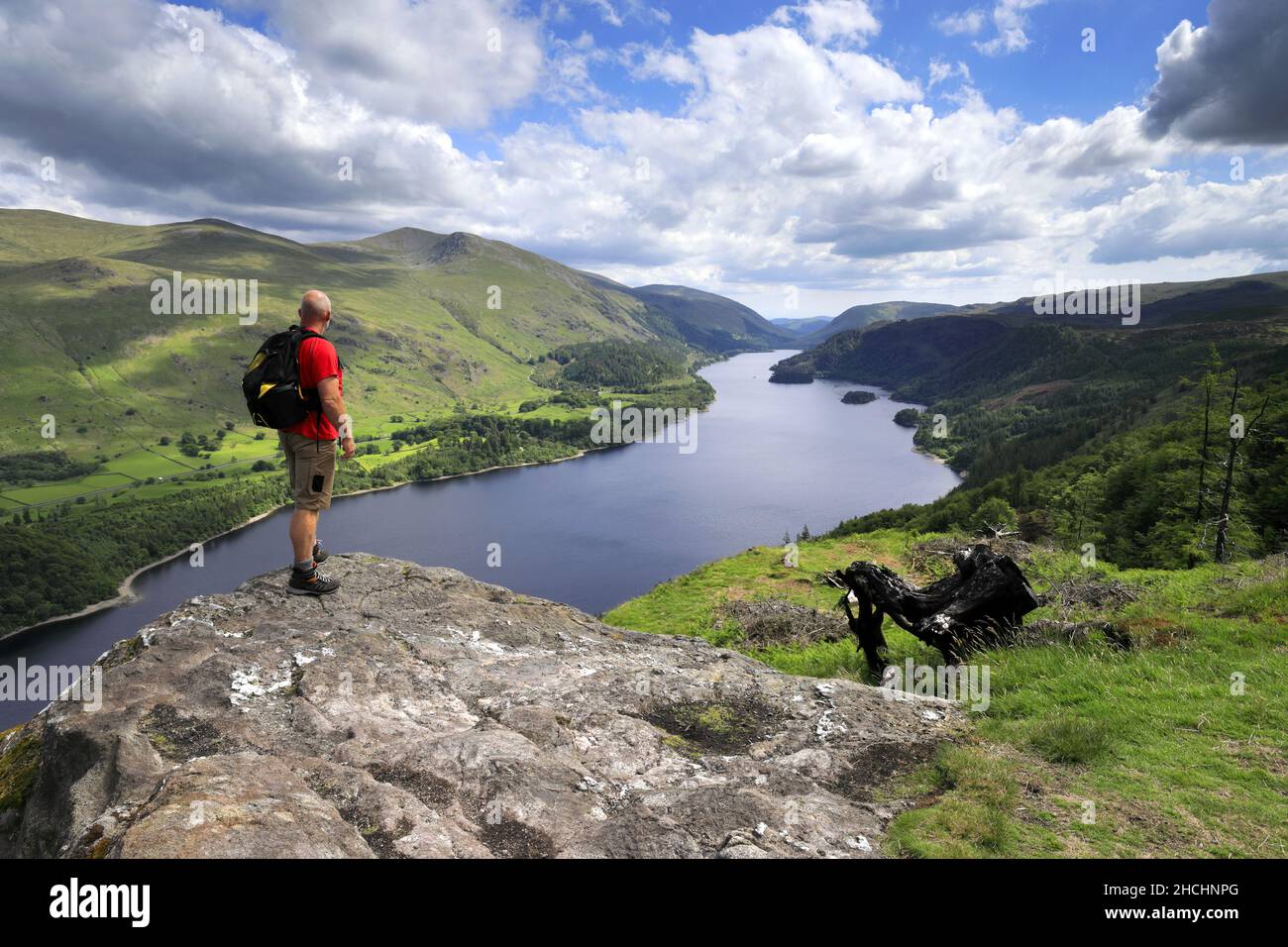 Walker at the summit cairn of Raven Crag fell overlooking Thirlmere ...