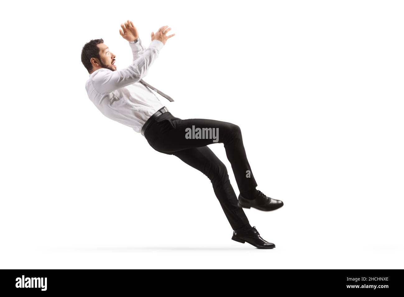Full length side shot of a man in formal clothes falling isolated on ...