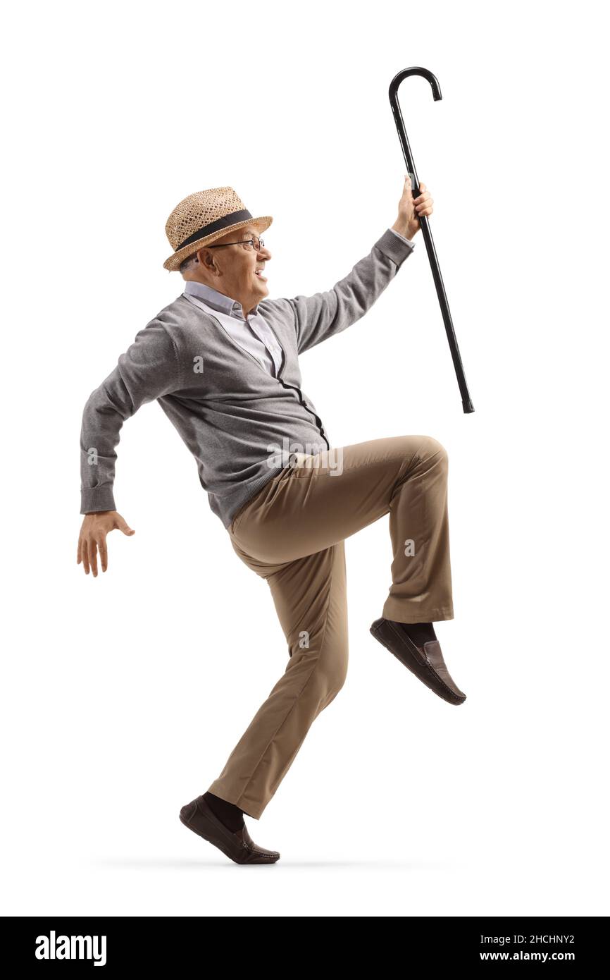 Full length profile shot of a senior man dancing with a cane isolated ...