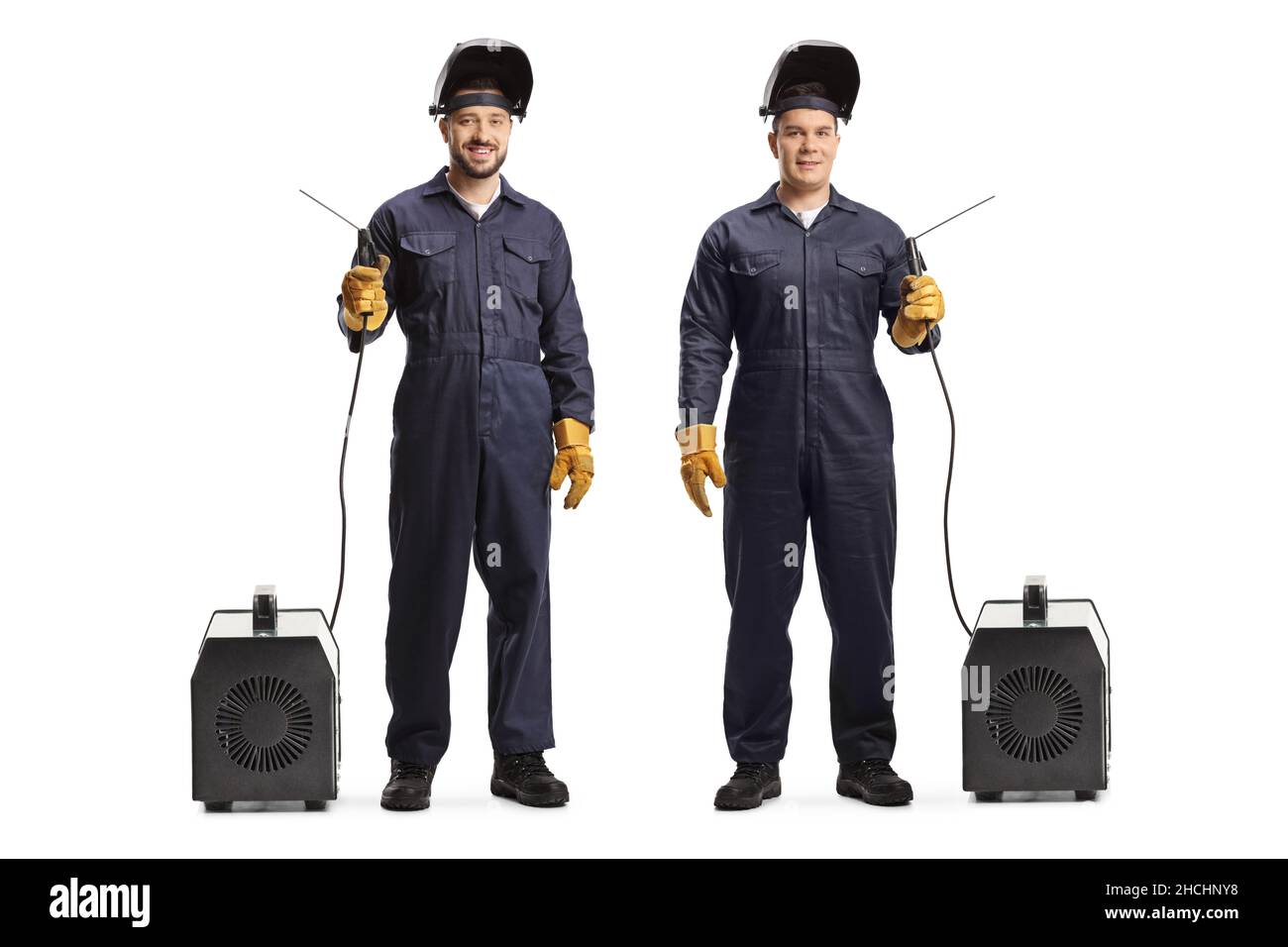 Full length portrait of two welders with welding machines isolated on ...