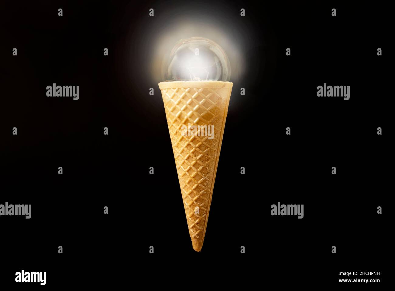Lit light bulb, in a ice cream cone, isolated on black background Stock ...