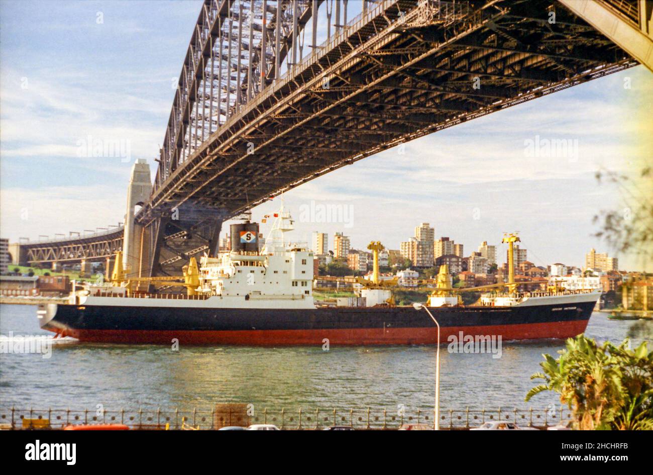 Cargo ship passing under Sydney Harbour Bridge. From Milsons Point ...