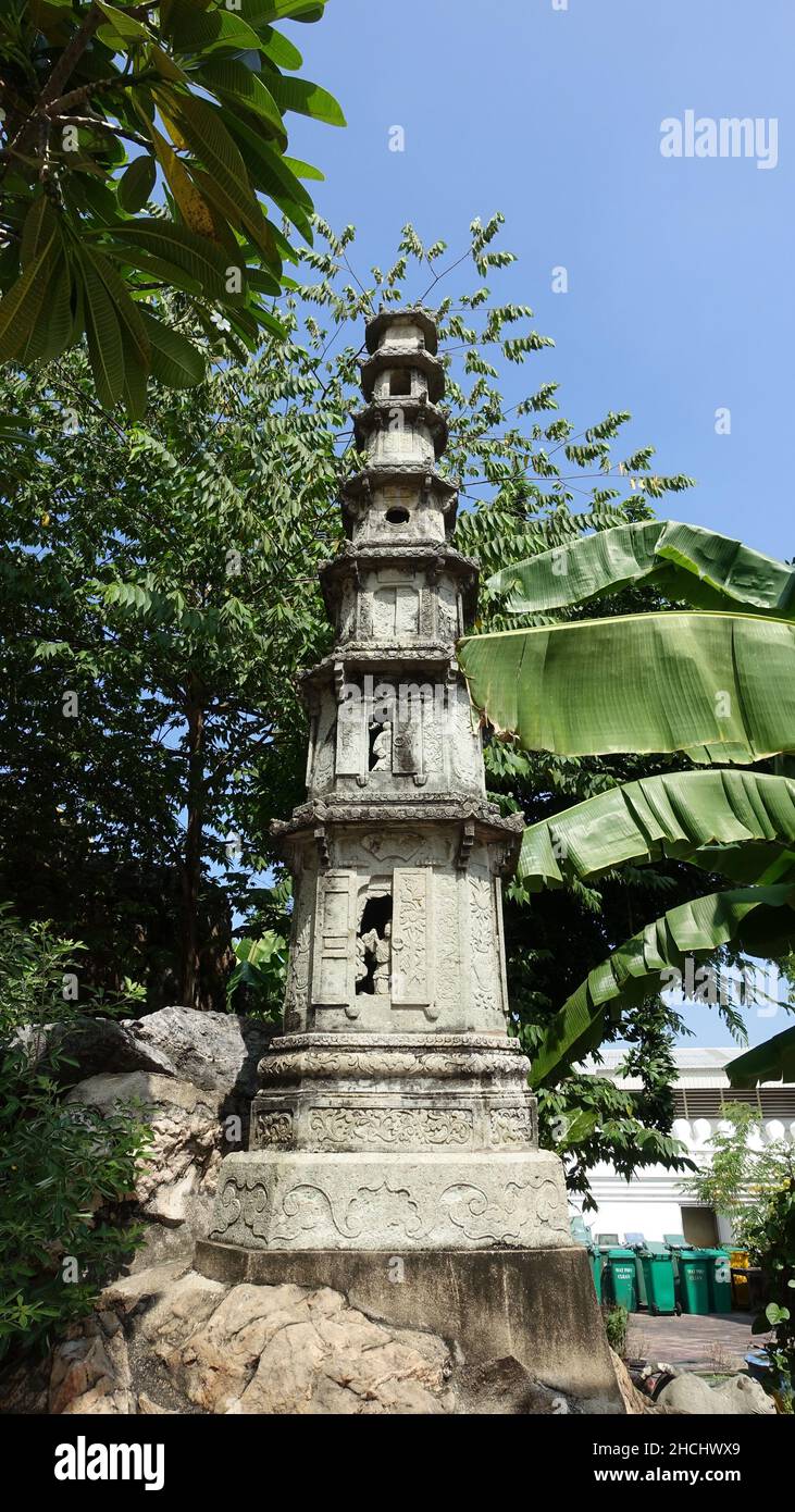 Flipped vertical shot of a structure surrounded by plants at a temple ...