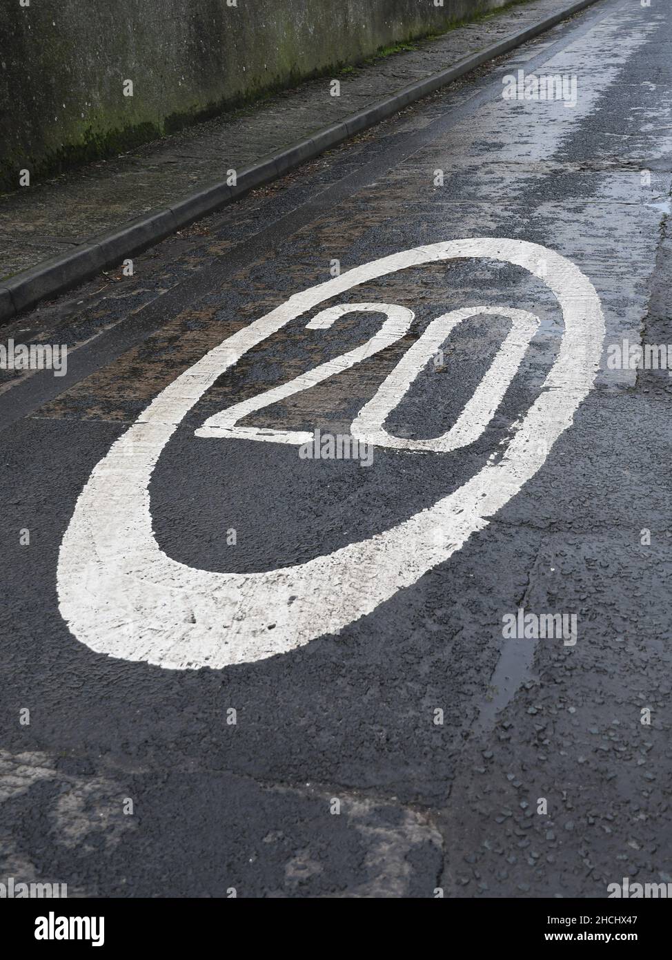 Twenty miles per hour (20 mph) road sign. 20 painted in white road ...