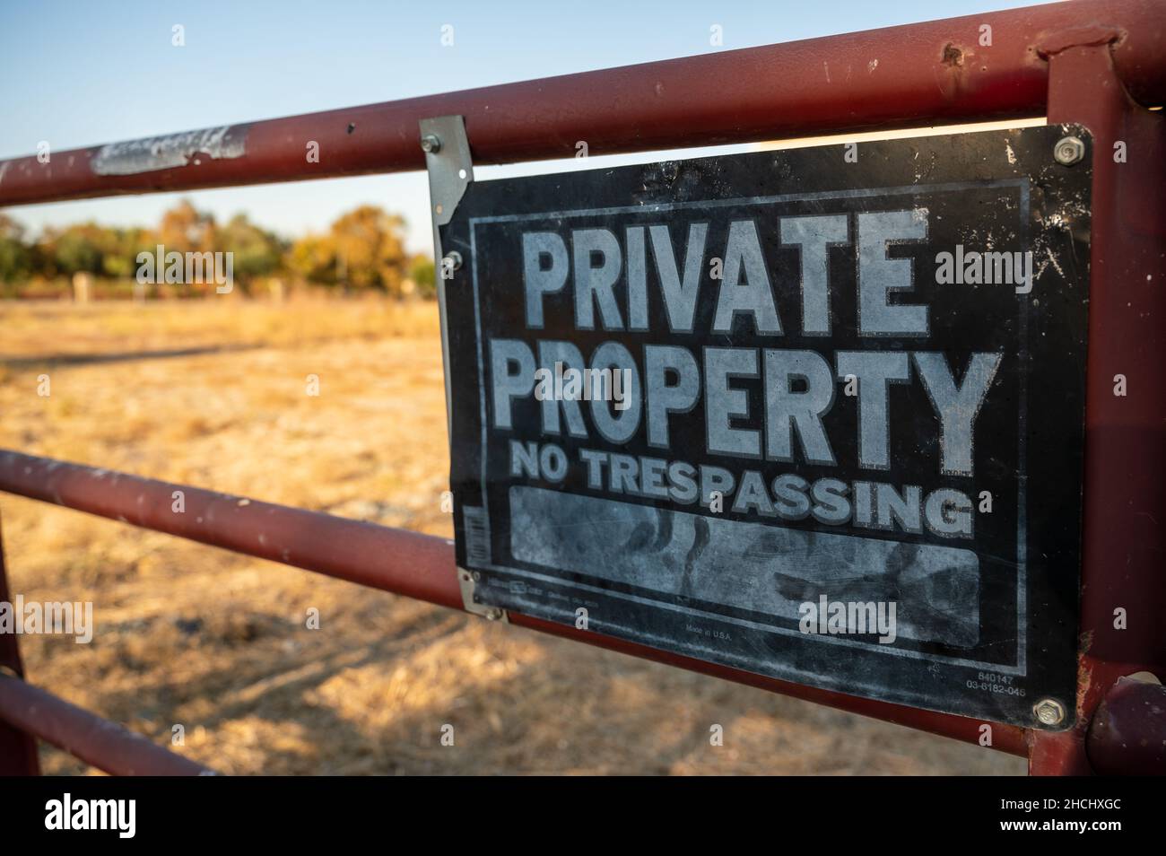 Closeup of a warning sign of private property on a black metal Stock ...