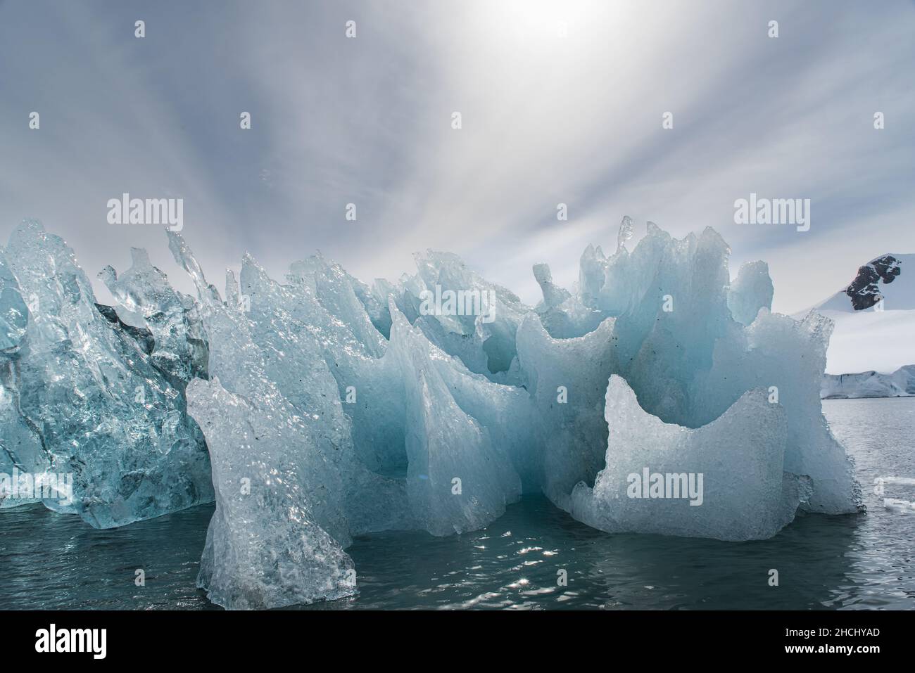 A photo of a backlit iceberg showing clear, blue and black ice with ...