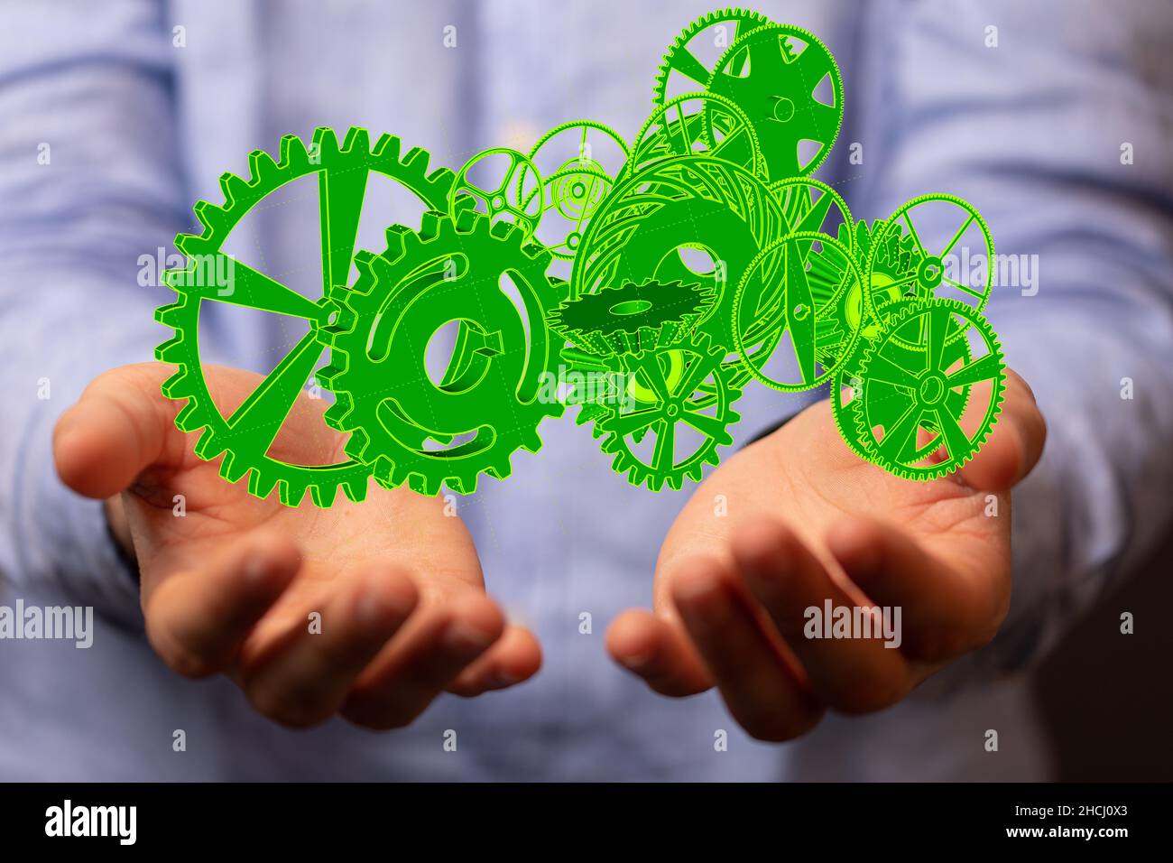 Closeup shot of hands with green gear icons above Stock Photo - Alamy