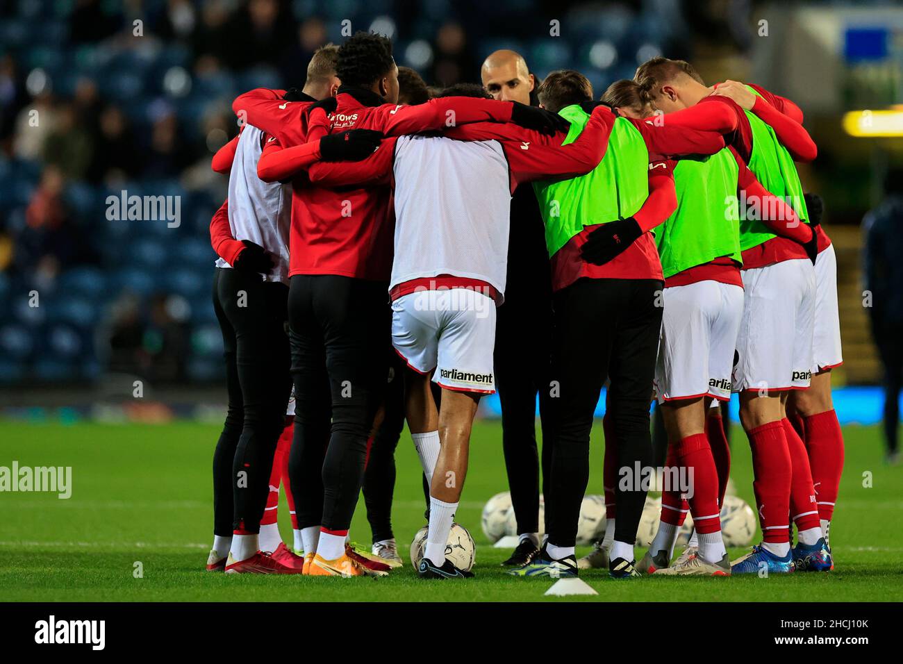 Barnsley players form team talk huddle during the warm up for the game ...
