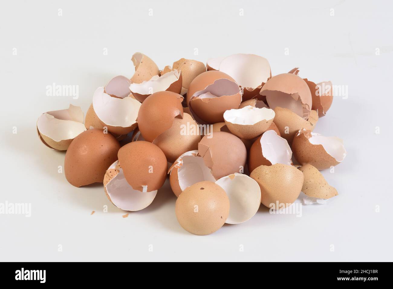 elevated view of pile of eggshells on white background Stock Photo - Alamy