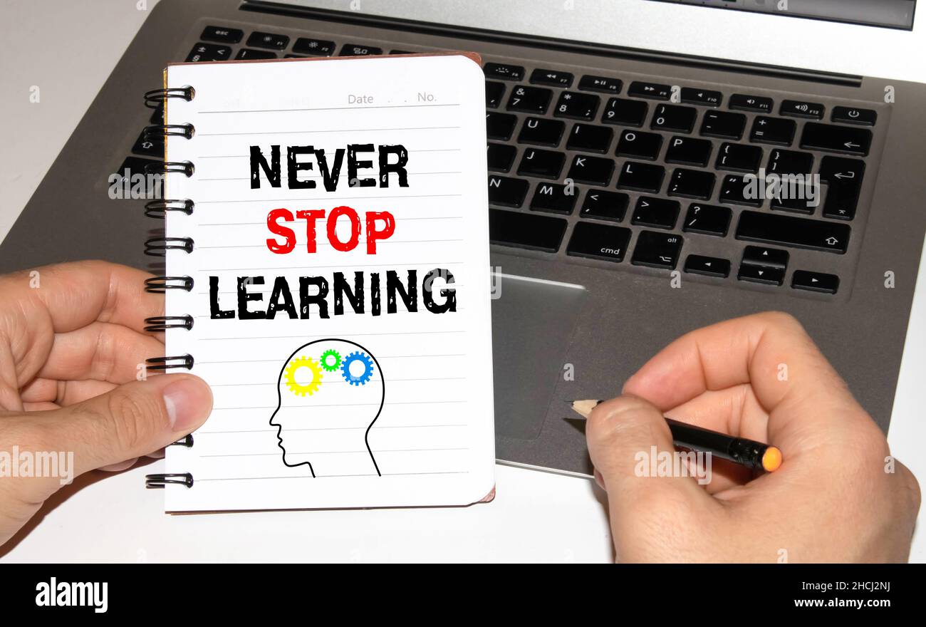 Never Stop Learning, handwriting quotation on notebook with light bulbs ...