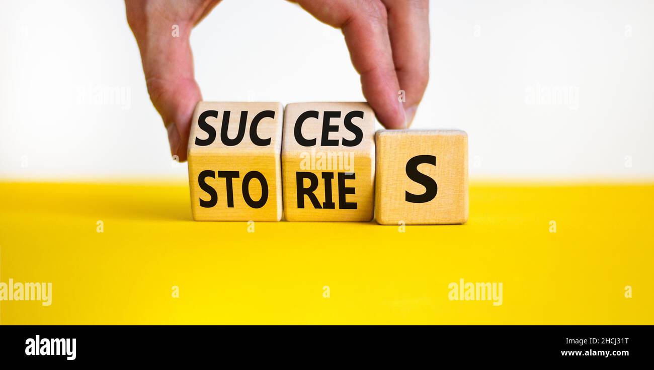 Success stories symbol. Businessman turns wooden cubes and changes the ...
