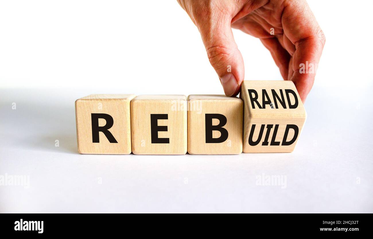 Rebrand and rebuild symbol. Businessman turnsa wooden cubes and changes ...