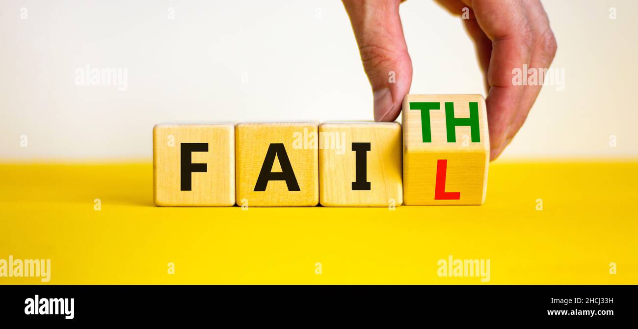 Faith instead fail symbol. Businessman turns a wooden cube and changes ...
