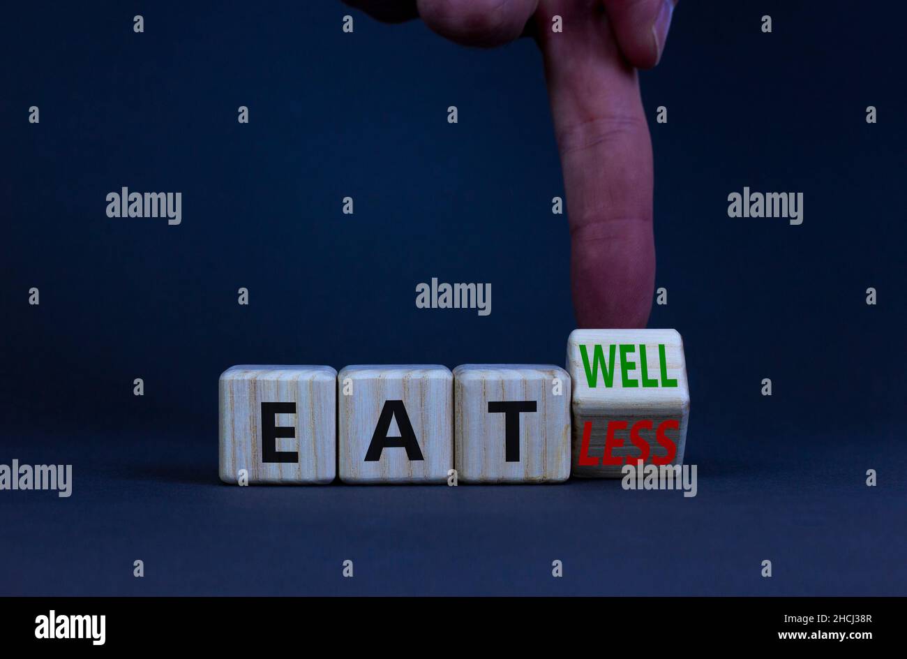 Eat well or eat less symbol. Businessman turns a wooden cube and ...