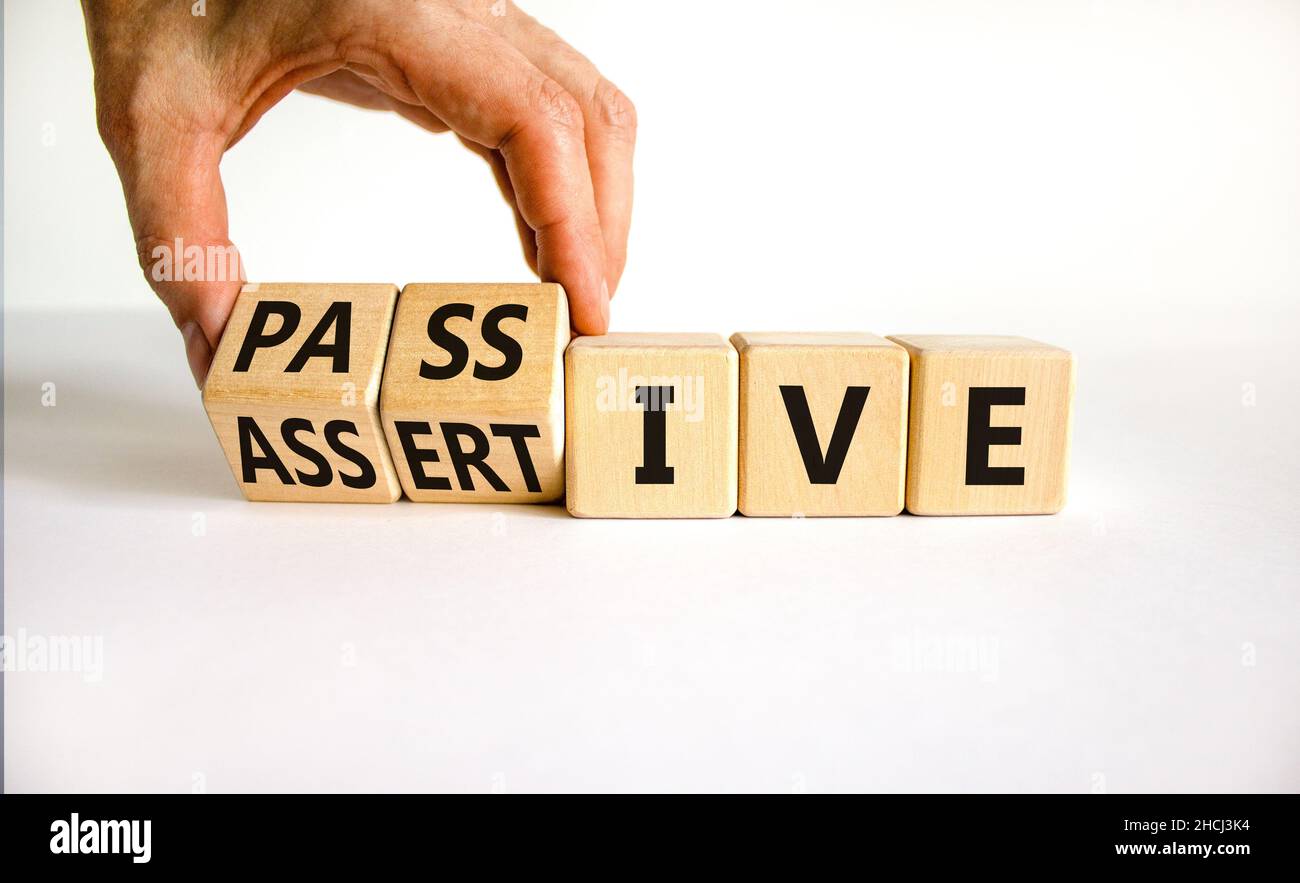 Passive or assertive symbol. Businessman turns wooden cubes and changes ...