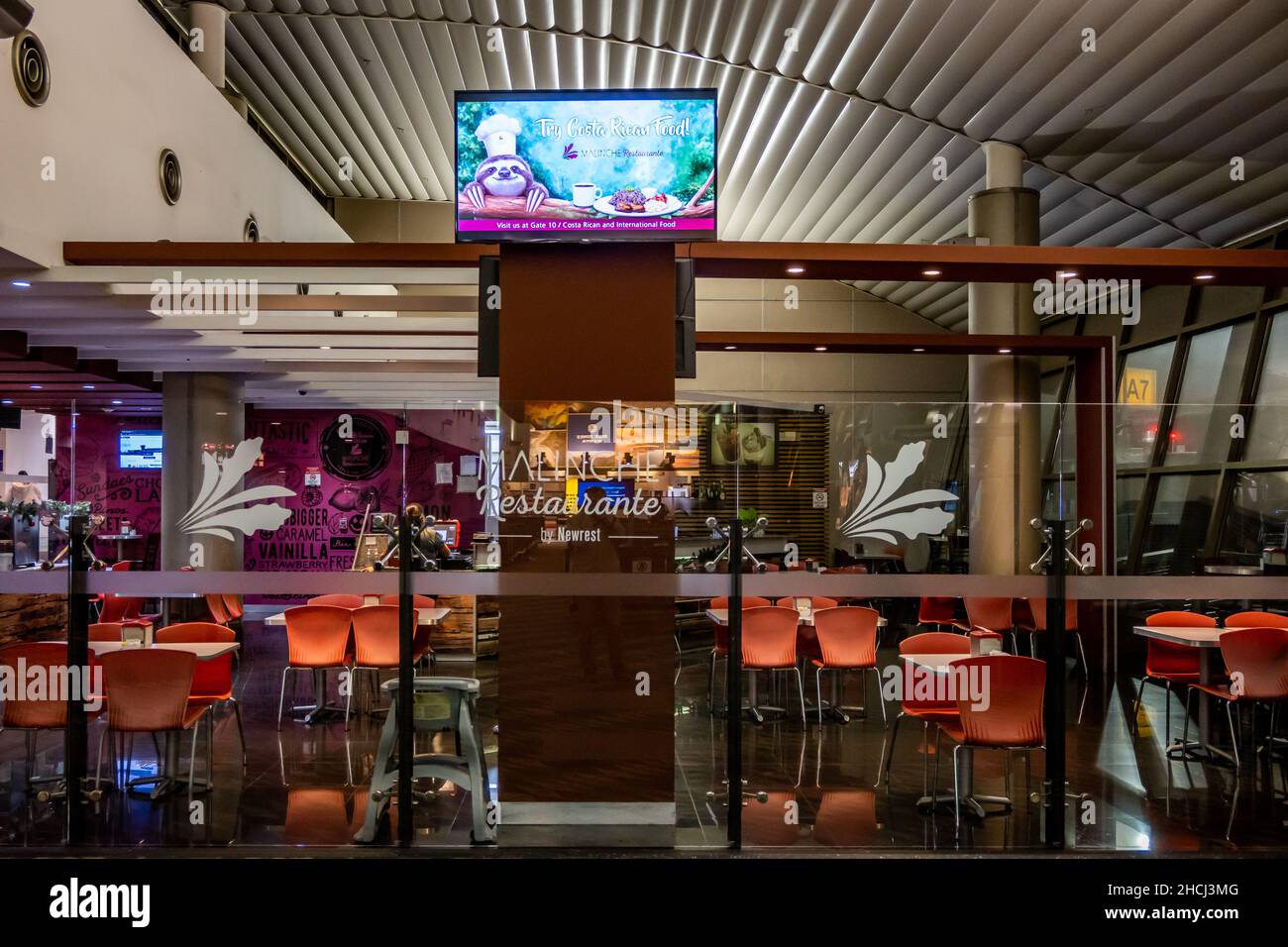 An empty restaurant inside ther terminal of San Jose Juan Santamaría ...