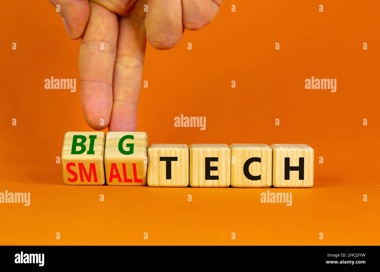 Big or small tech symbol. Businessman turns wooden cubes and changes ...
