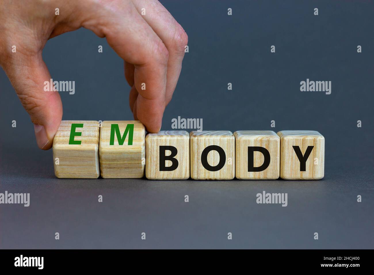 Body and embody symbol. Doctor turns wooden cubes and changes the ...