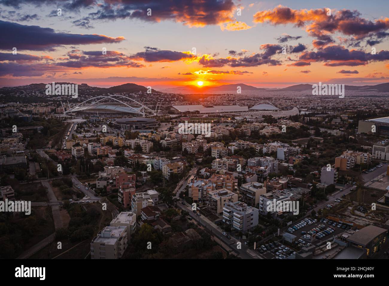 Sunset aerial view of northern Athens with Olympic OAKA complex in the ...