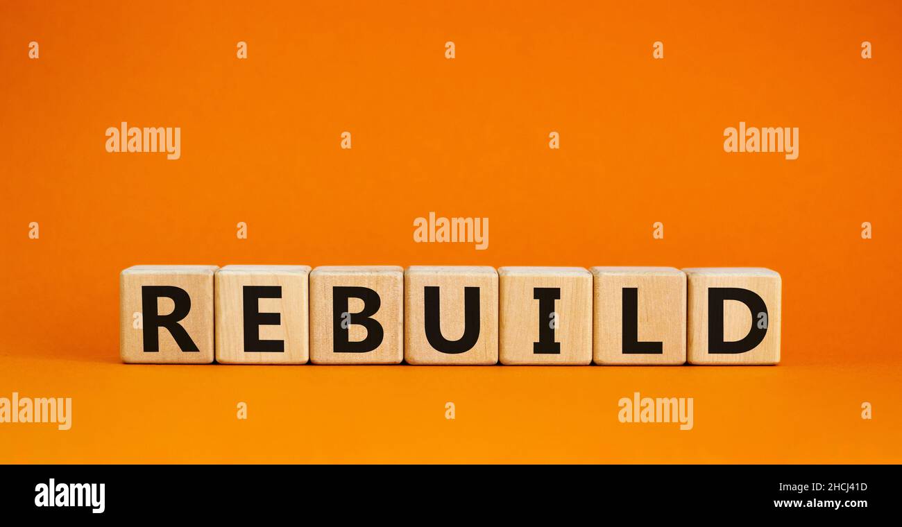 Rebuild and build symbol. The concept word Rebuild on wooden cubes ...