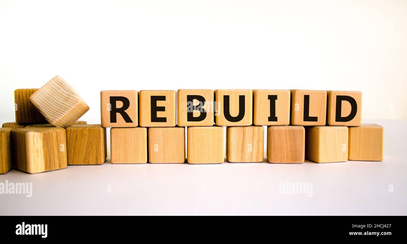 Rebuild and build symbol. The concept word Rebuild on wooden cubes ...