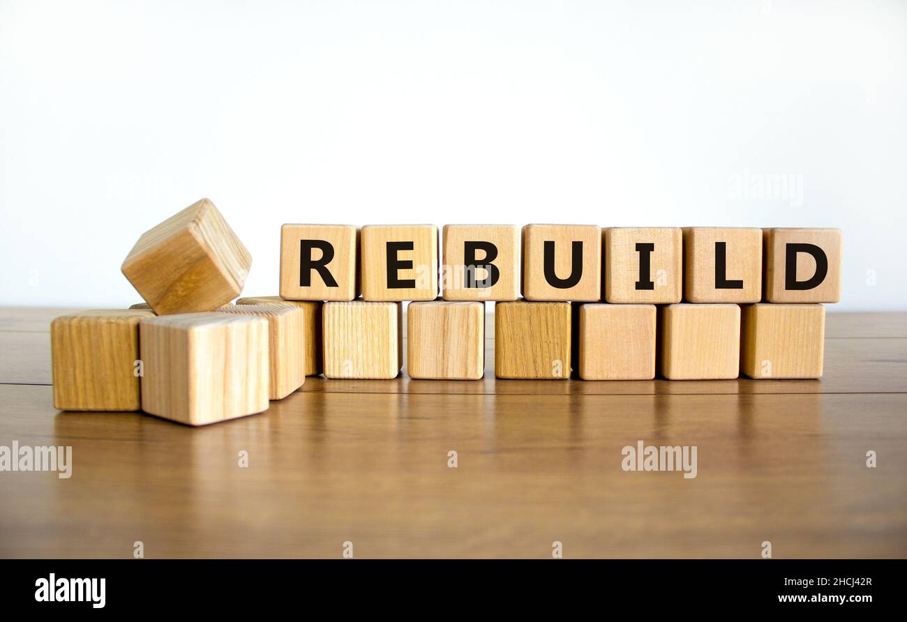 Rebuild and build symbol. The concept word Rebuild on wooden cubes ...