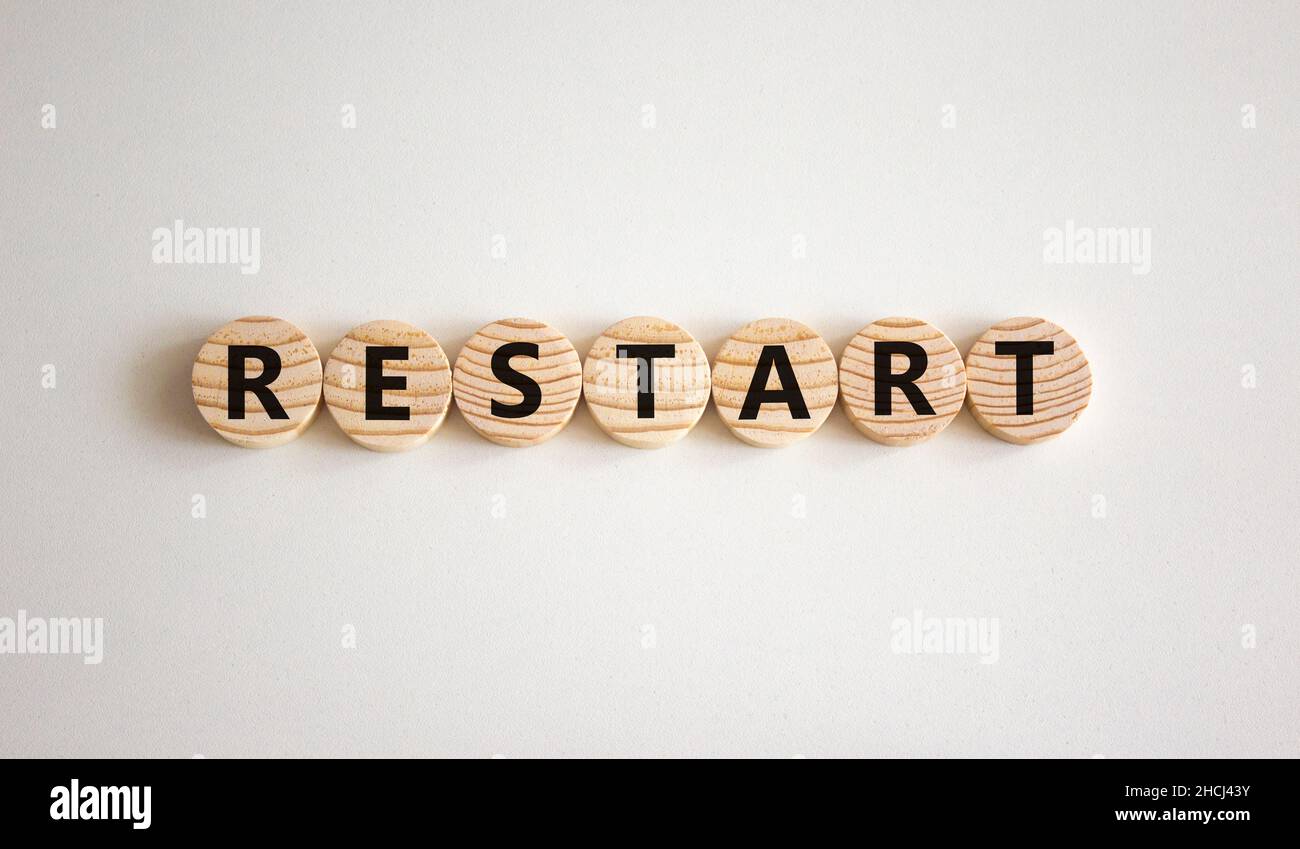 Restart and start symbol. The concept word Restart on wooden circles ...