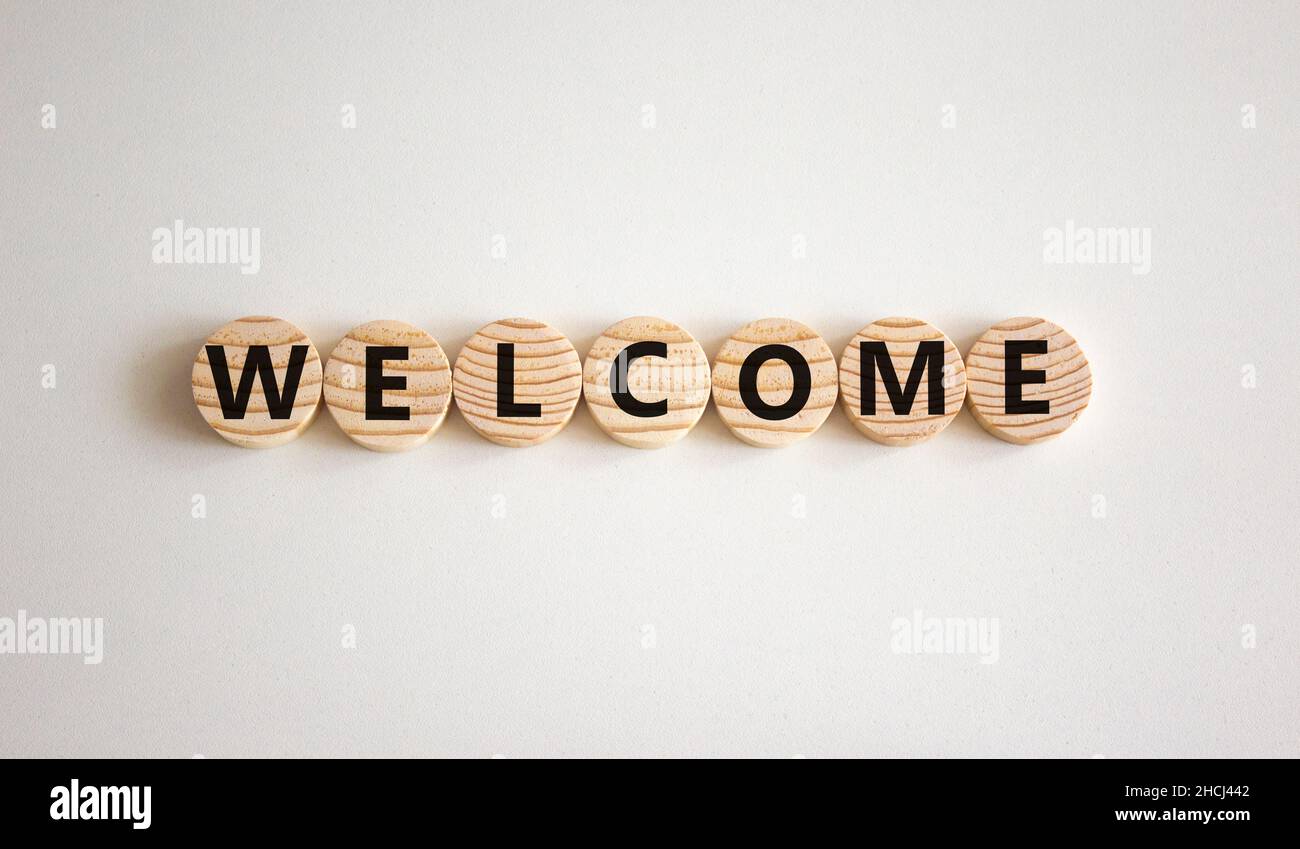 Welcome and support symbol. The concept word Welcome on wooden circles ...