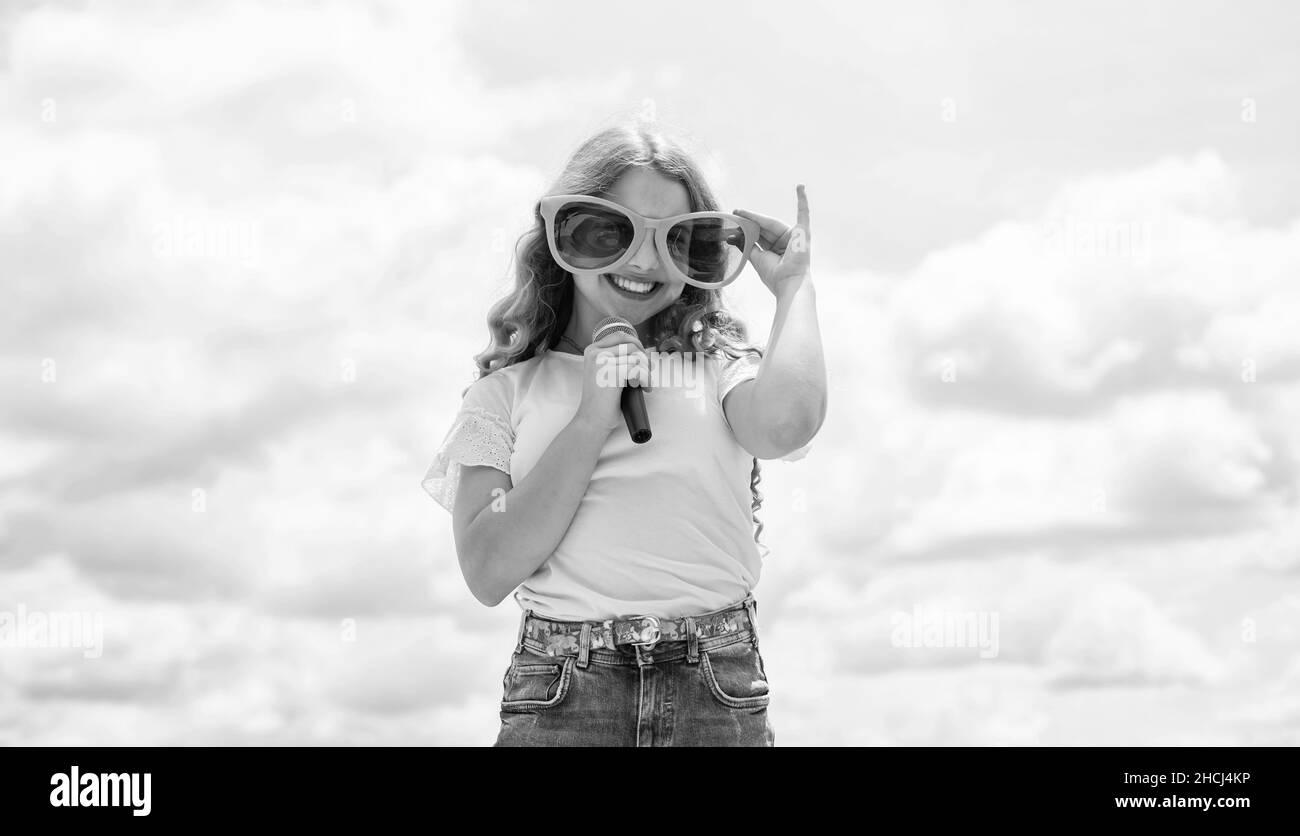 child singing outdoor. singer with microphone. happy childhood. happy ...