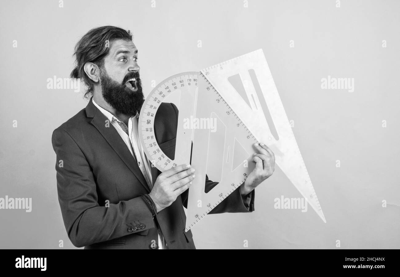 back to school. measure and size. surprised mature teacher holding ...