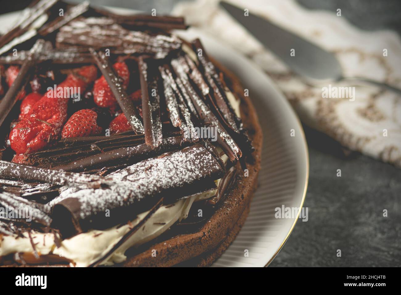 Top view of chocolate marquise cake with red berries resting on a ...