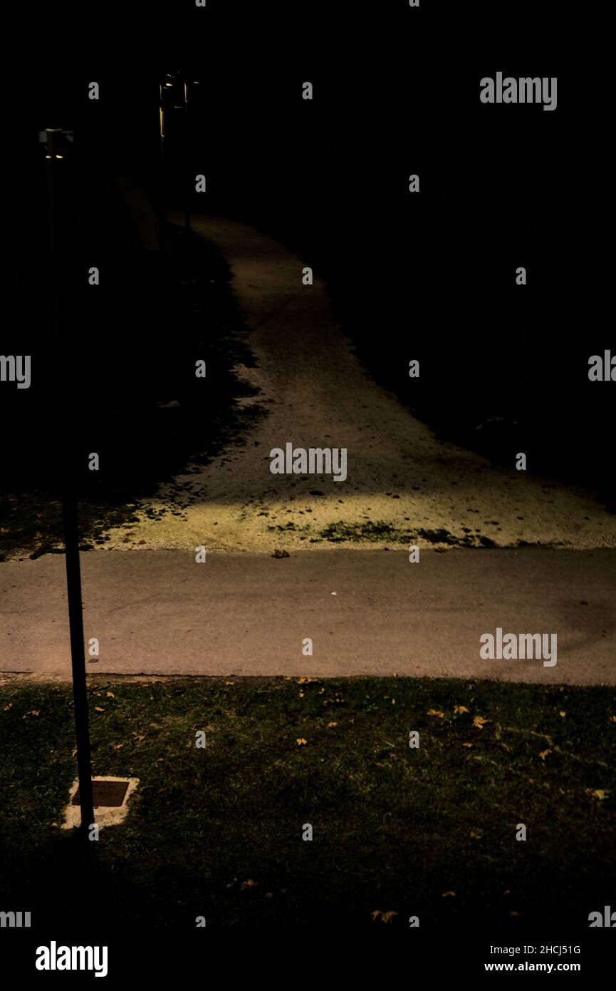 Path in a park at night seen from above Stock Photo - Alamy