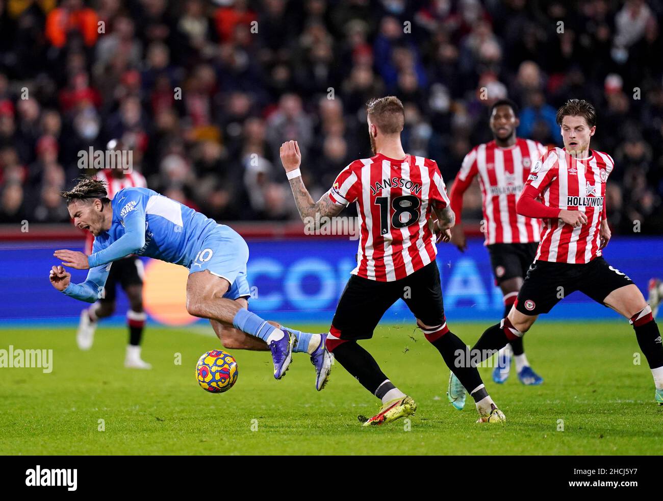 Manchester City's Jack Grealish (left) goes down after a challenge by Brentford's Pontus Jansson ...
