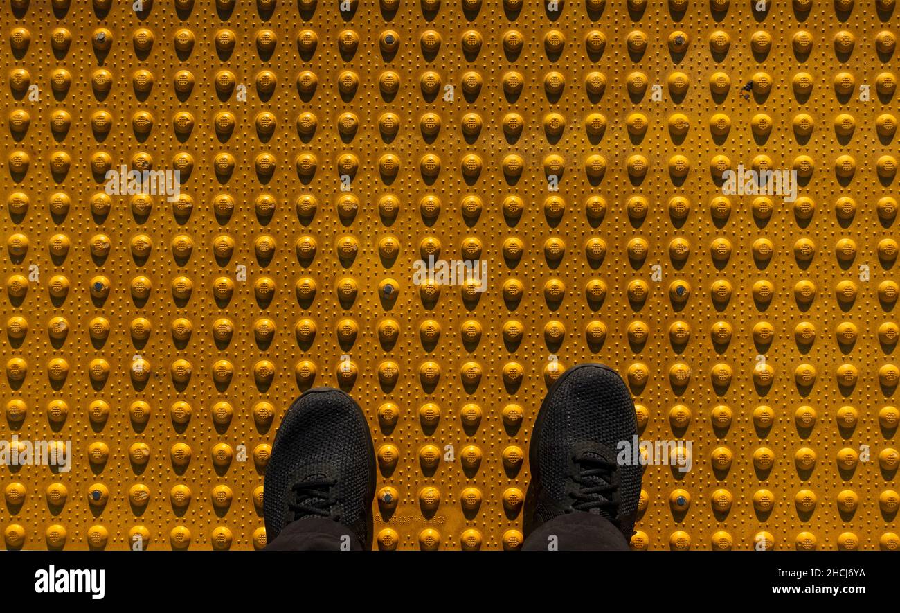 textured yellow safety line on the platform of subway station in ...