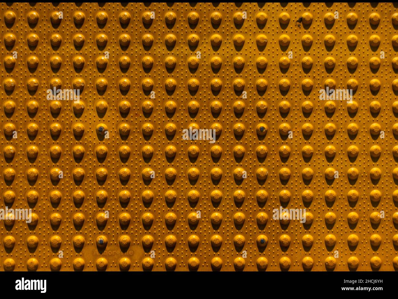 textured yellow safety line on the platform of subway station in ...