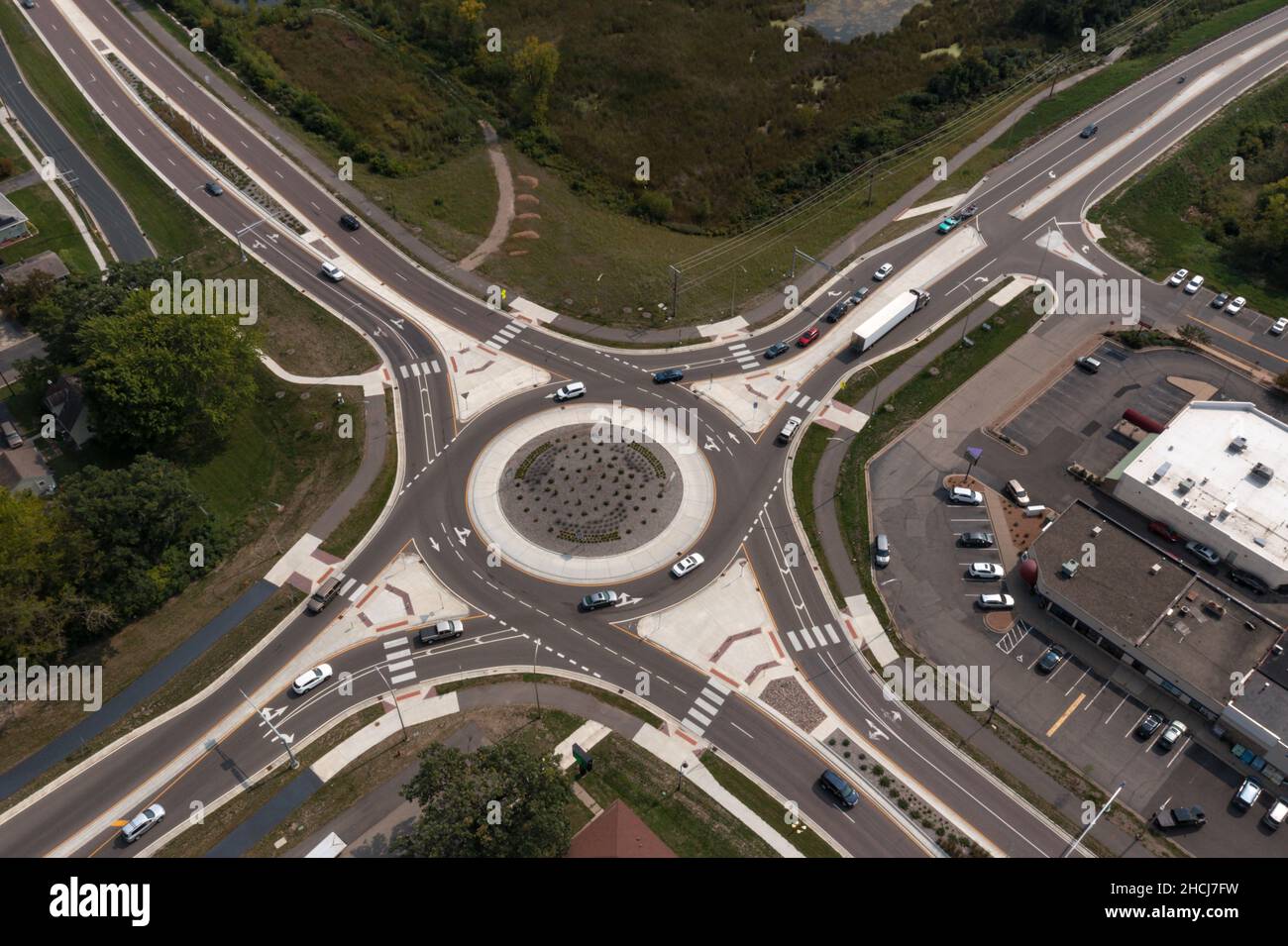 Traffic Moves Around Roundabout From Above Summer - drone aerial Stock ...